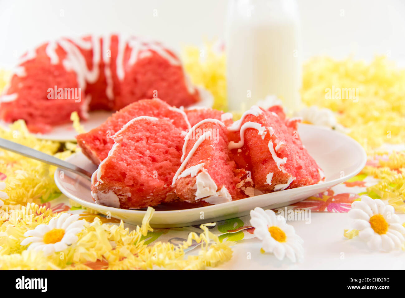 pink cherry pudding cake and a jug of milk Stock Photo - Alamy