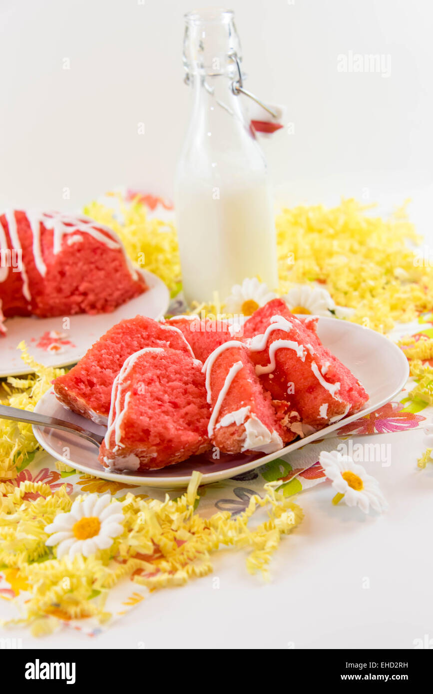 pink cherry pudding cake and a jug of milk Stock Photo - Alamy
