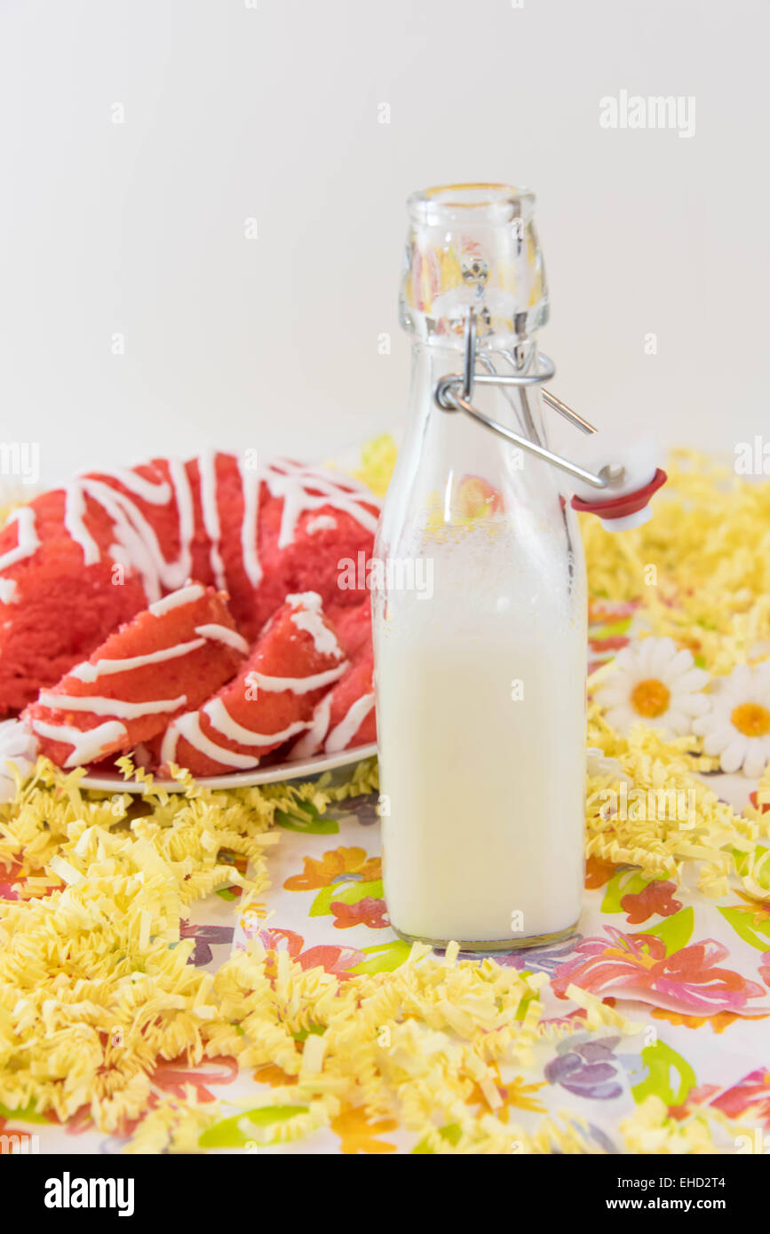 pink cherry pudding cake and a jug of milk Stock Photo - Alamy