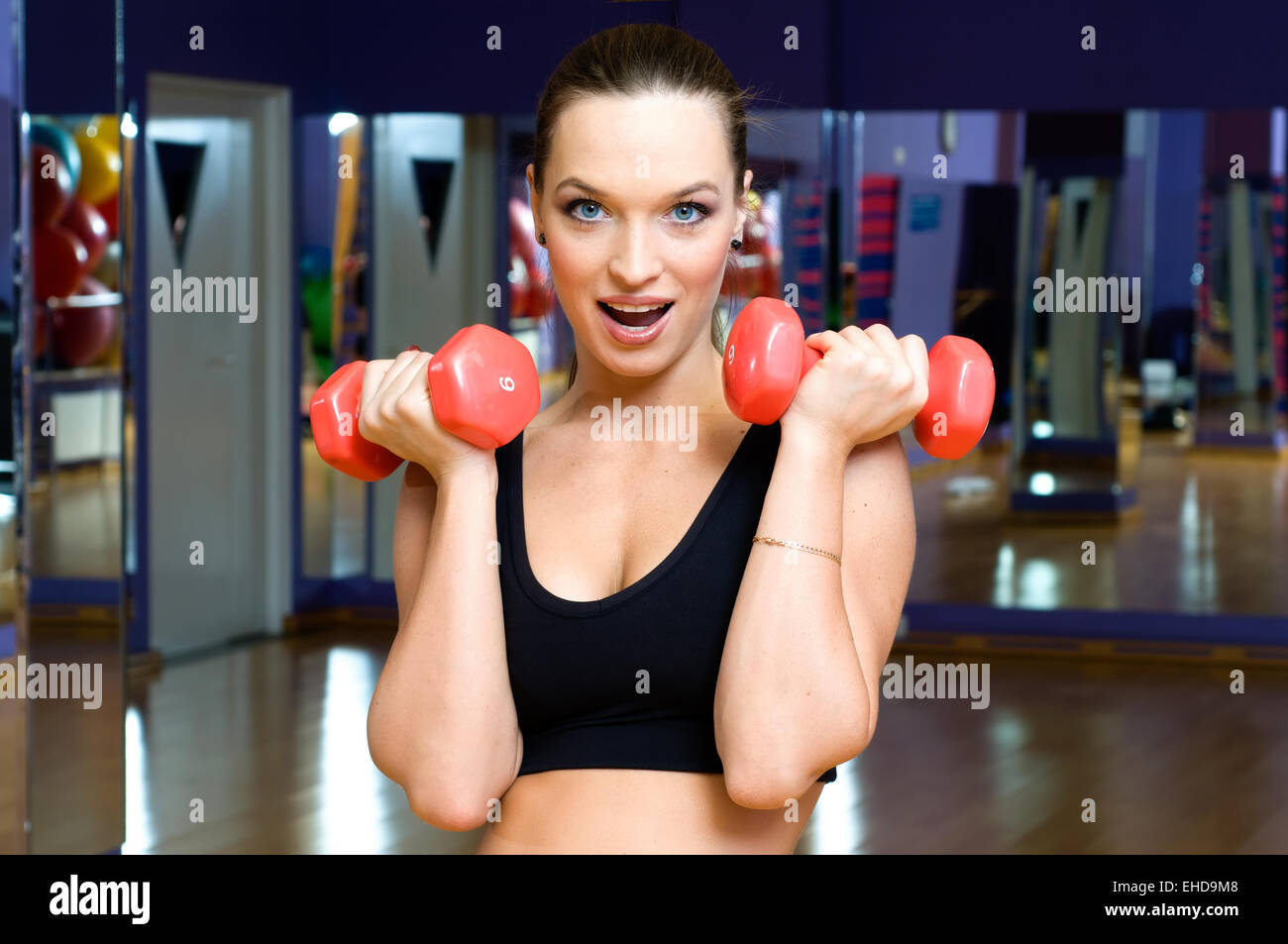 Woman with dumbbells Stock Photo - Alamy
