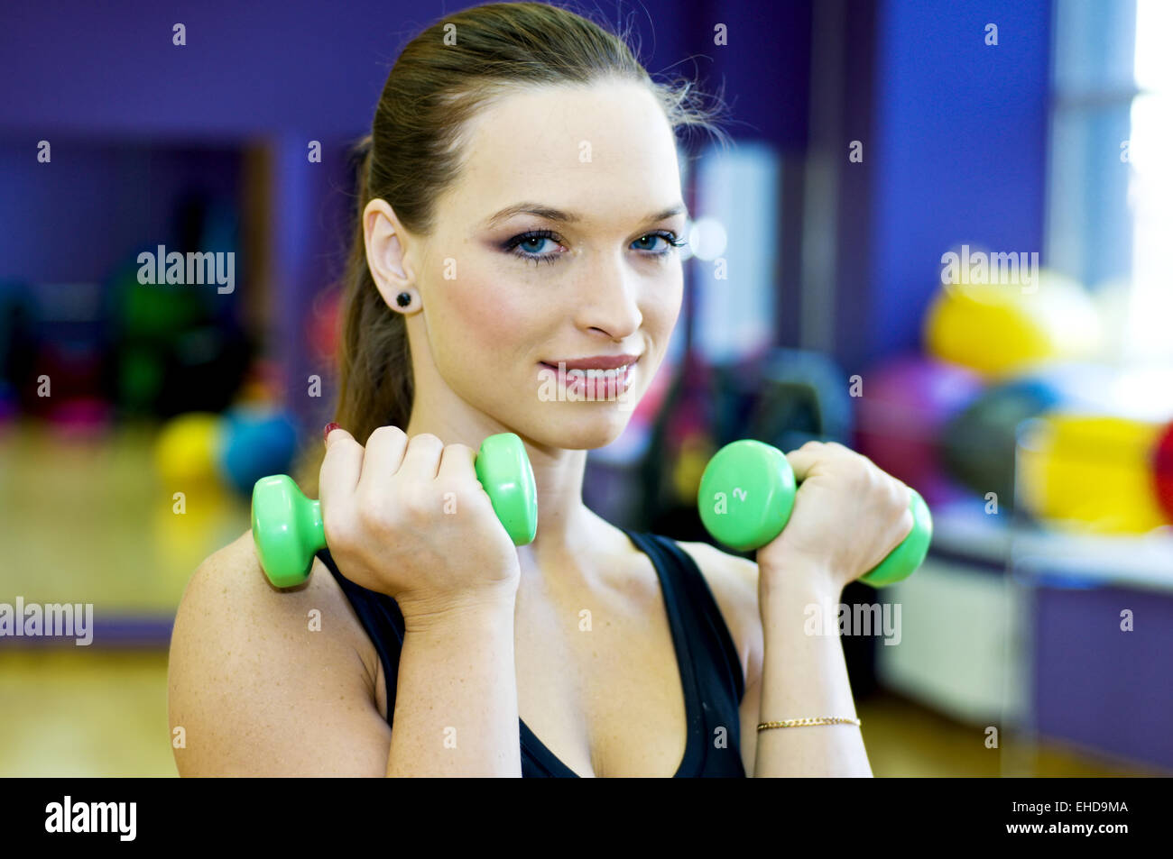 Woman with dumbbells Stock Photo - Alamy