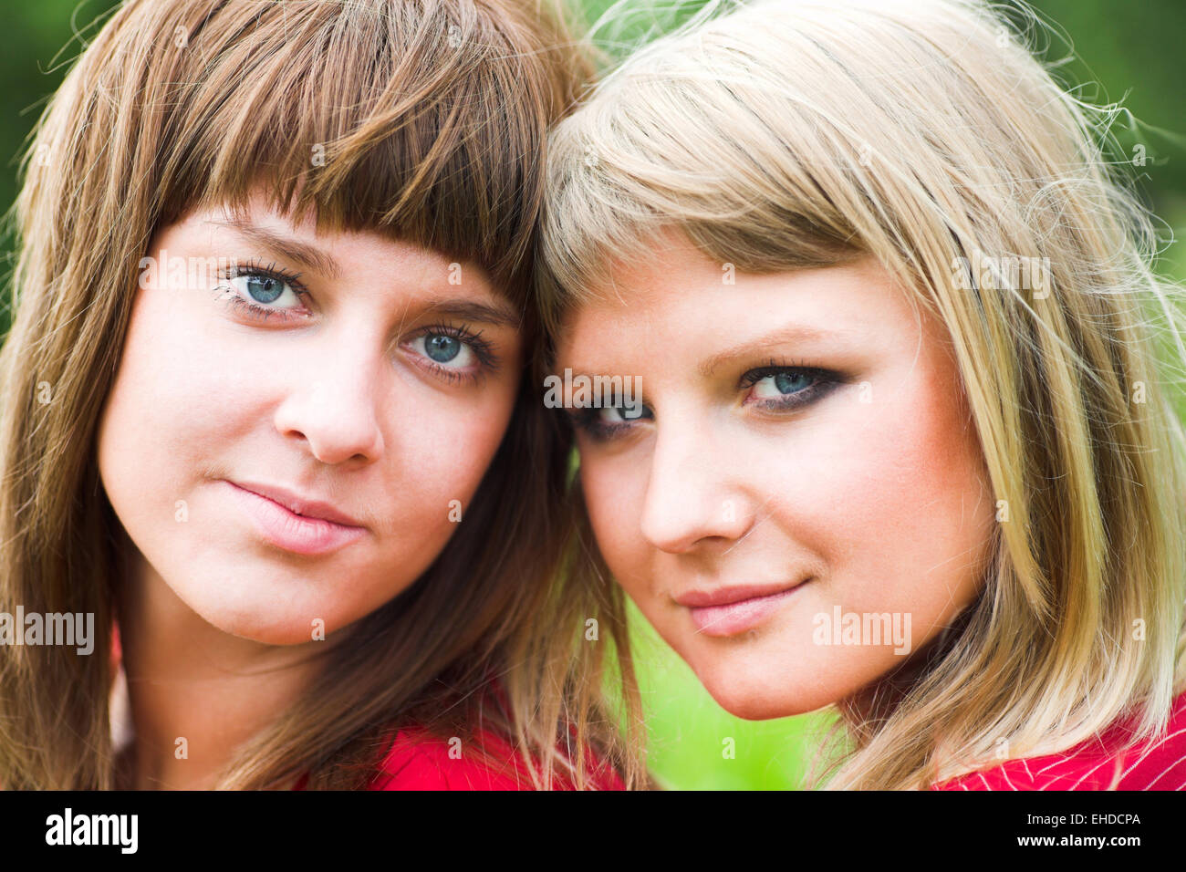 Two girls in red in park Stock Photo - Alamy
