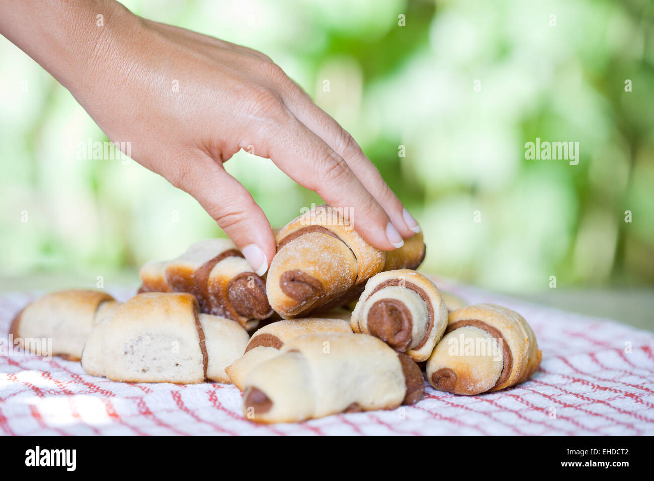 Woman hand taking one of sweet homemade cake Stock Photo - Alamy