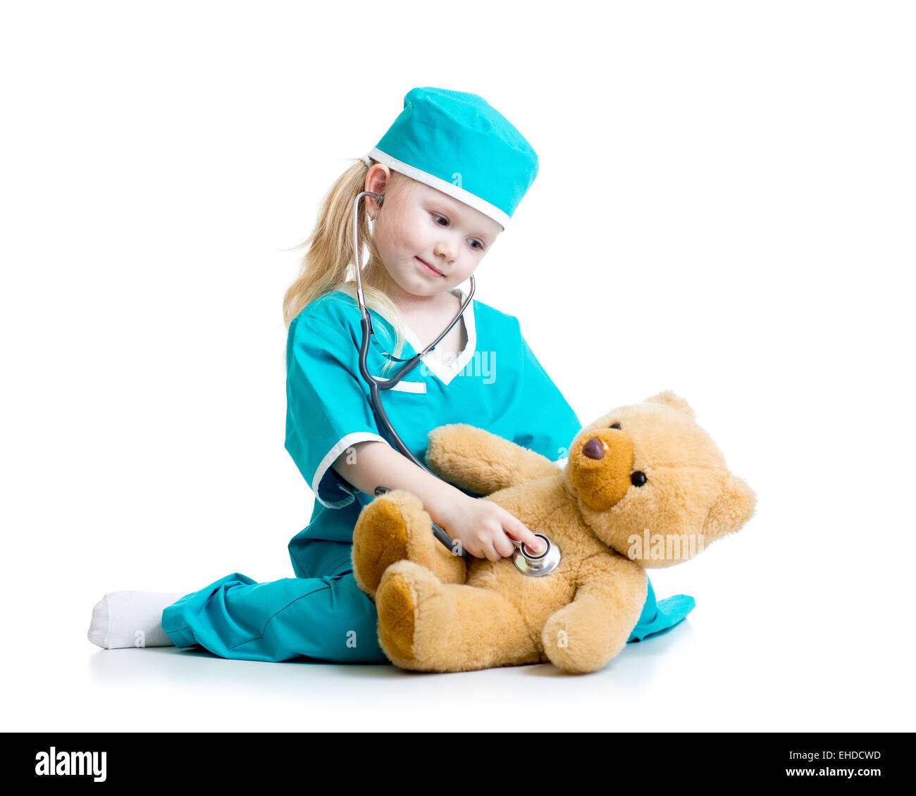 Adorable child with clothes of doctor examining bear toy Stock Photo ...