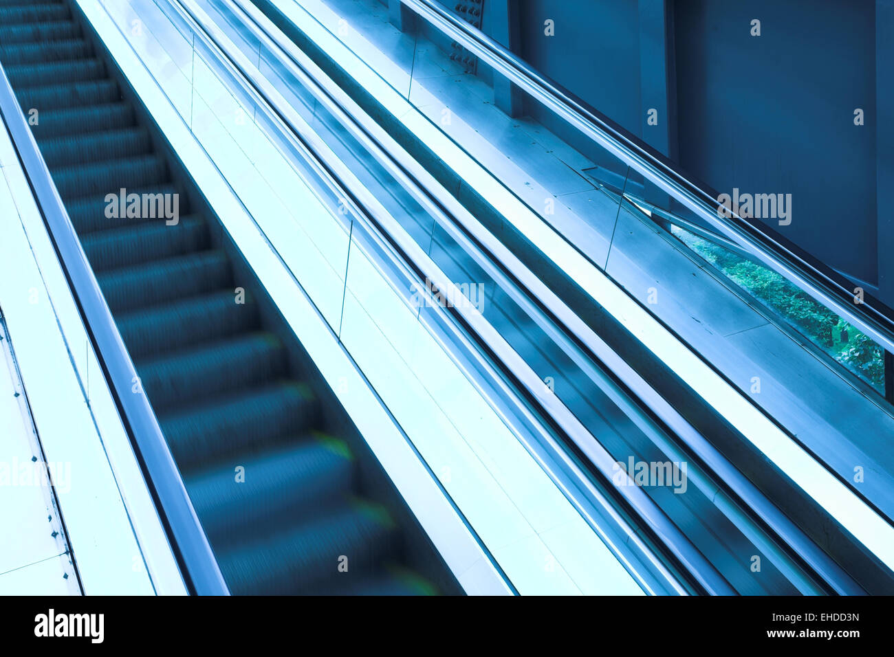 Blue move escalator in modern office centre Stock Photo - Alamy