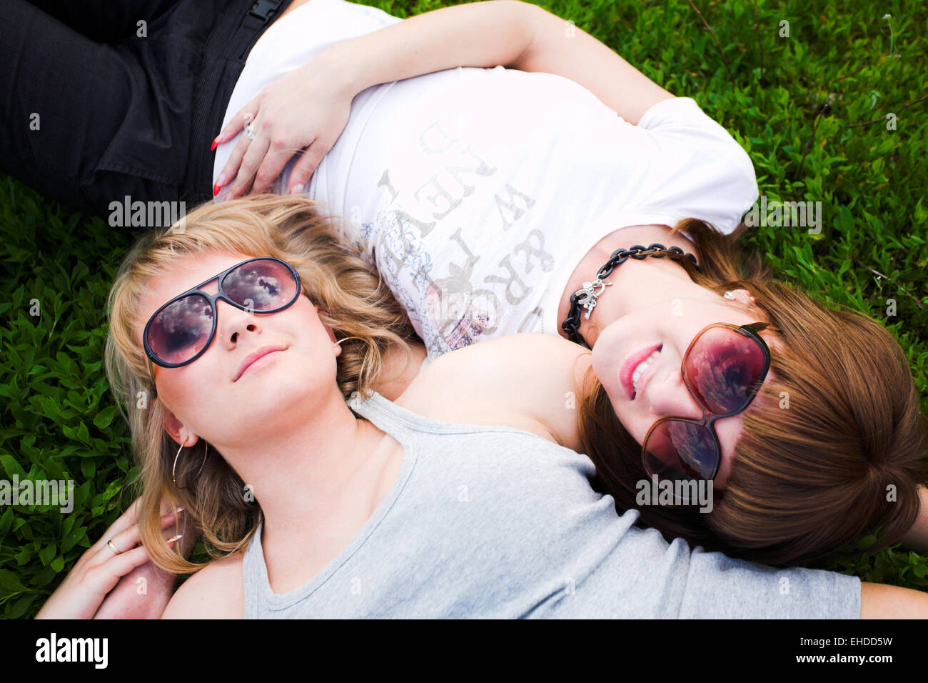Two girls laying in grass hi-res stock photography and images - Alamy