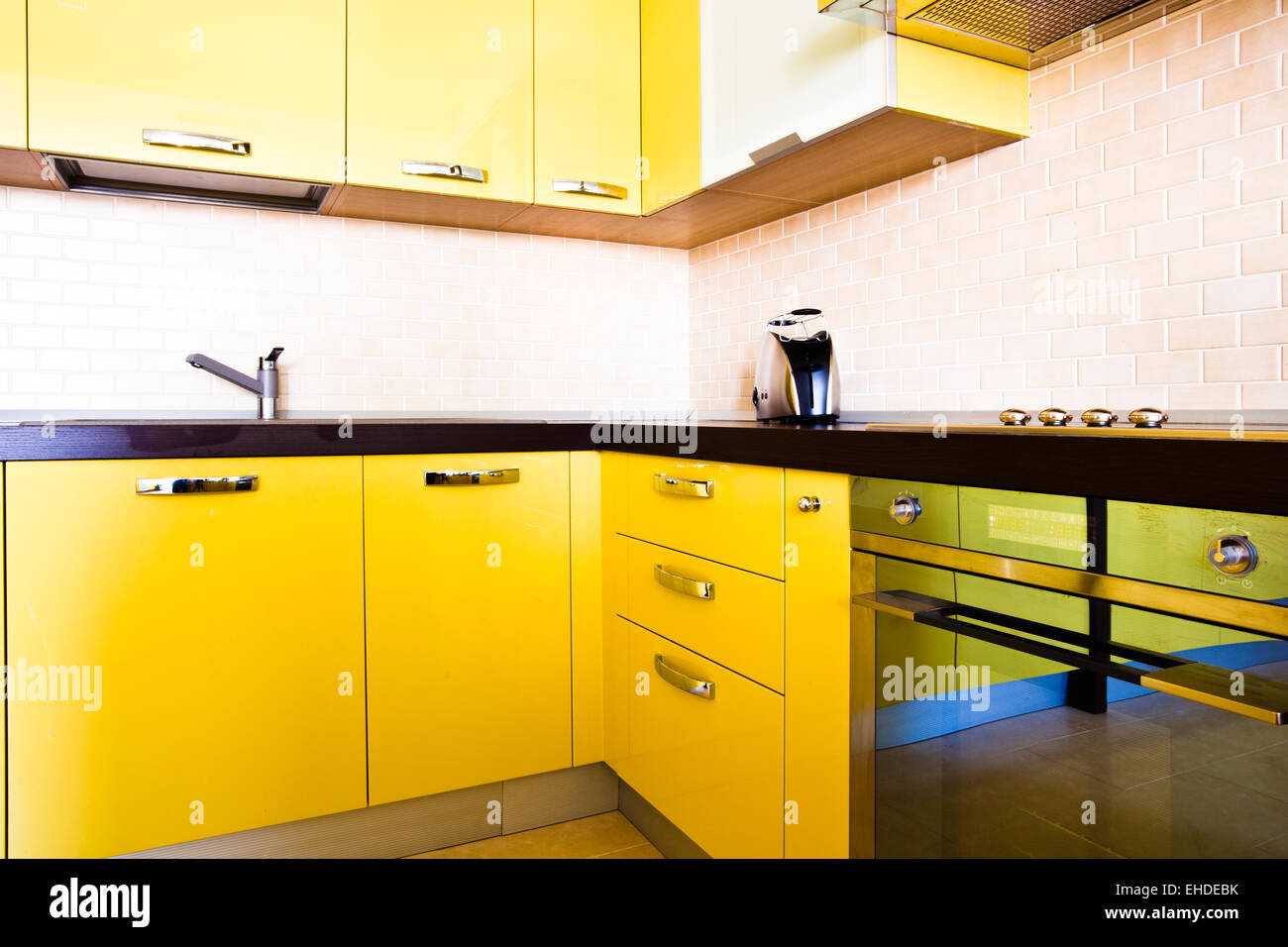Yellow kitchen interior in modern flat Stock Photo - Alamy