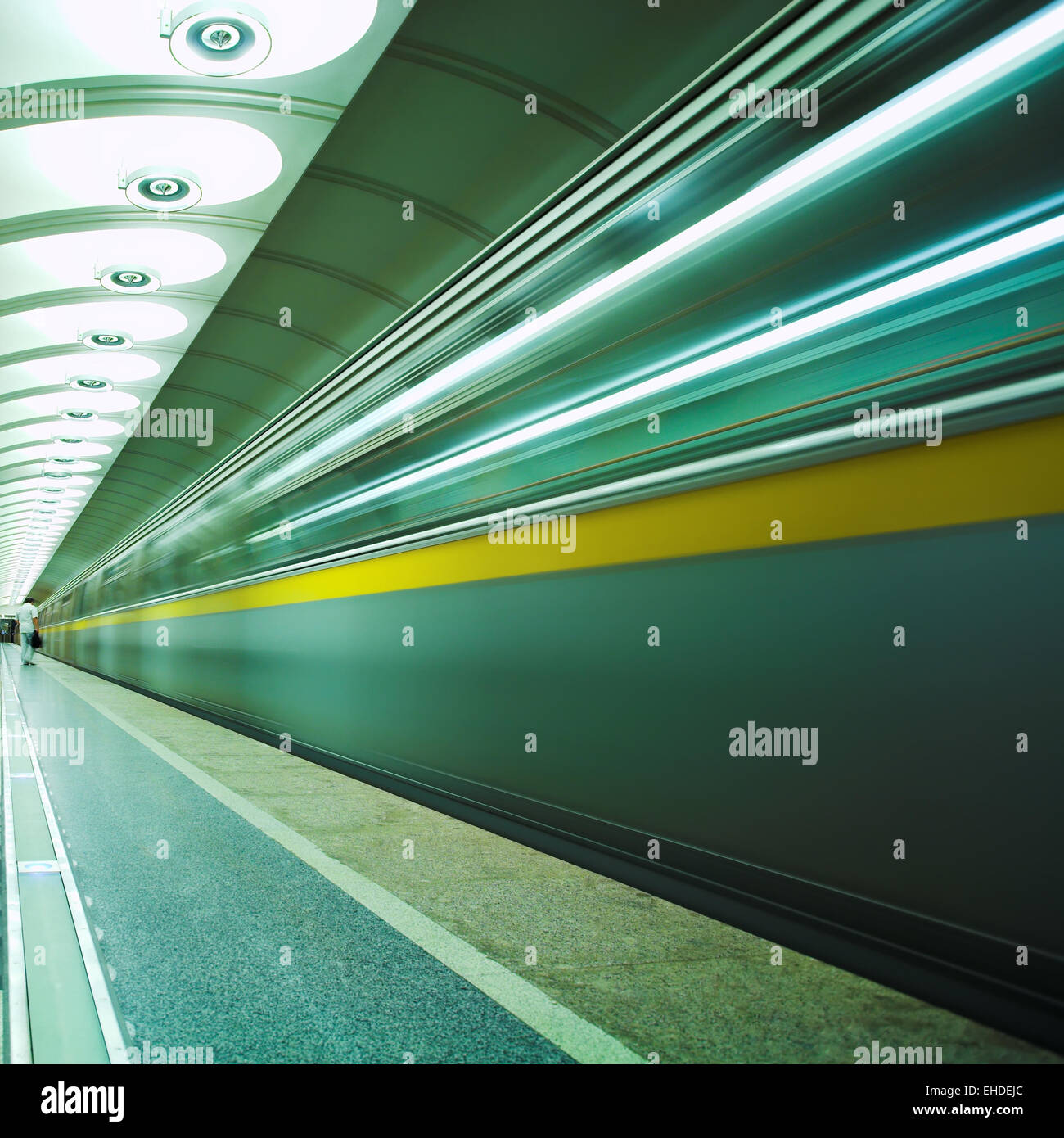 Move train in green on platform in subway Stock Photo - Alamy