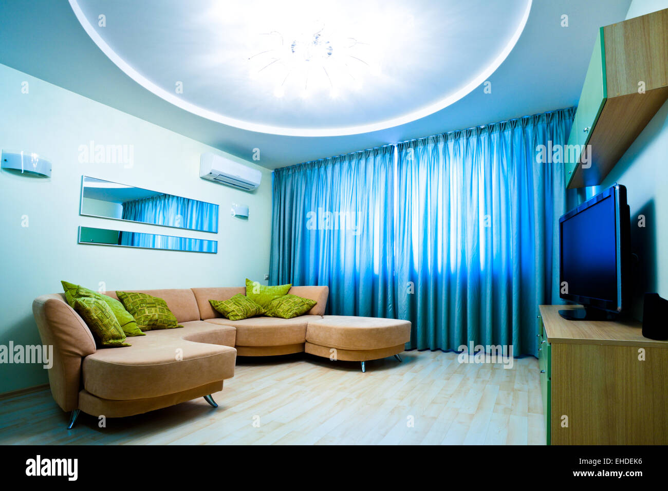 Modern blue room interior with TV and sofa Stock Photo - Alamy