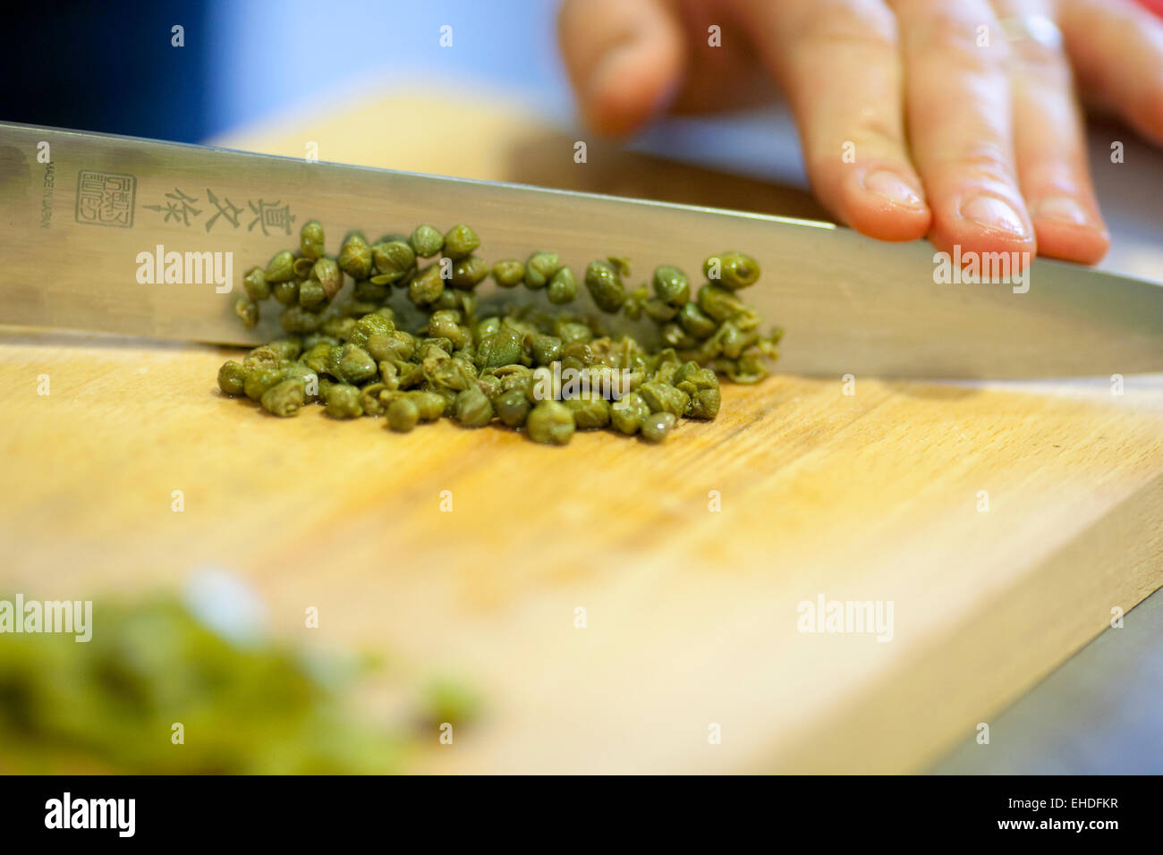 capers knife chopping board action Stock Photo - Alamy