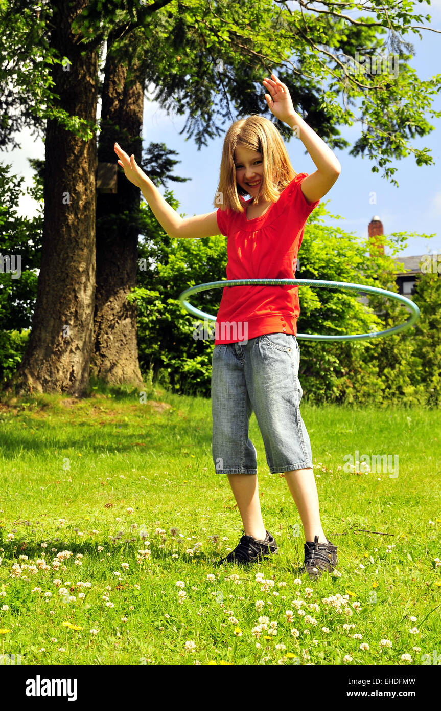 Child in the garden hopping jumping Stock Photo - Alamy