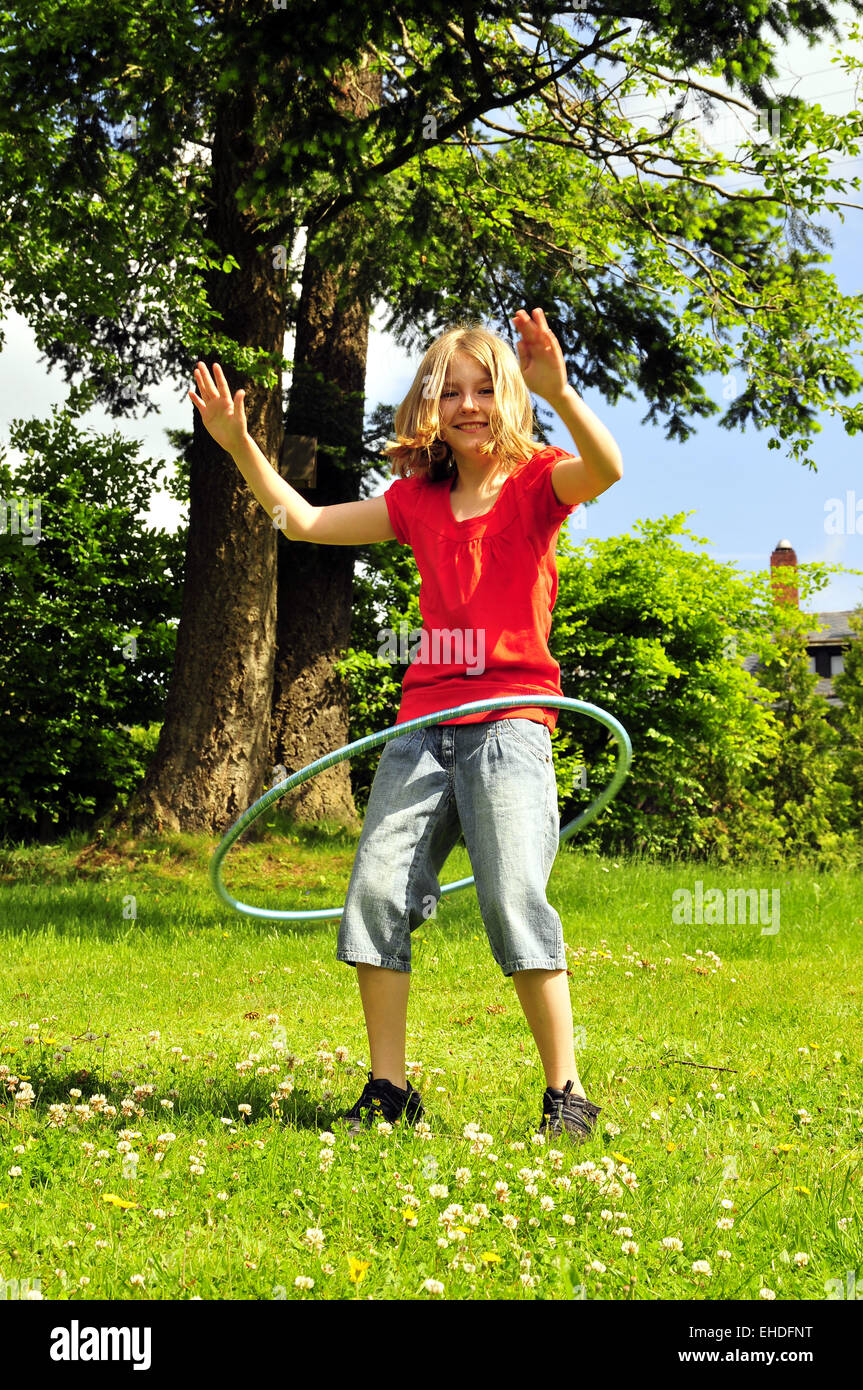 Child in the garden hopping jumping Stock Photo - Alamy