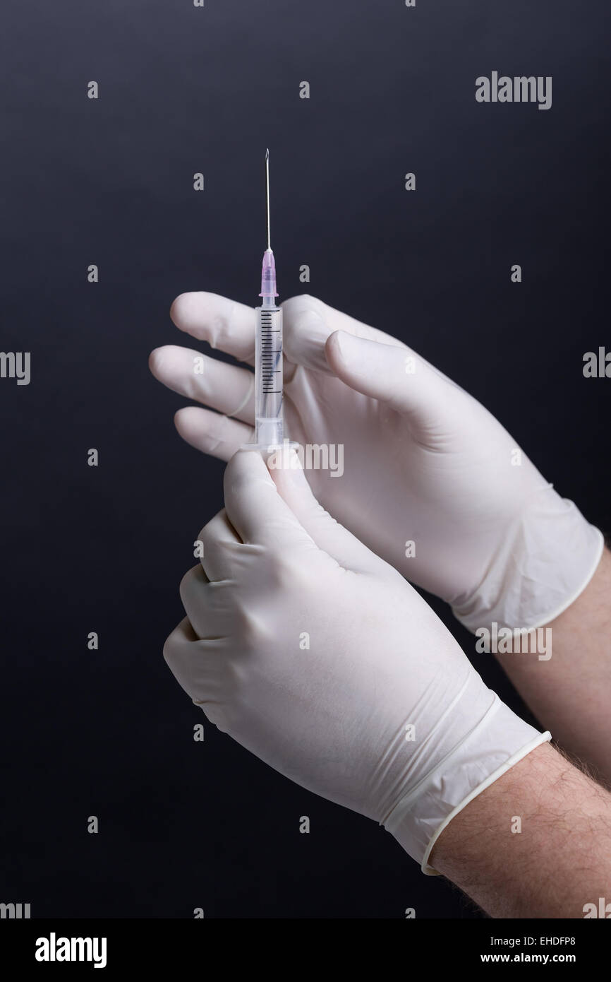 Hands with syringe Stock Photo - Alamy