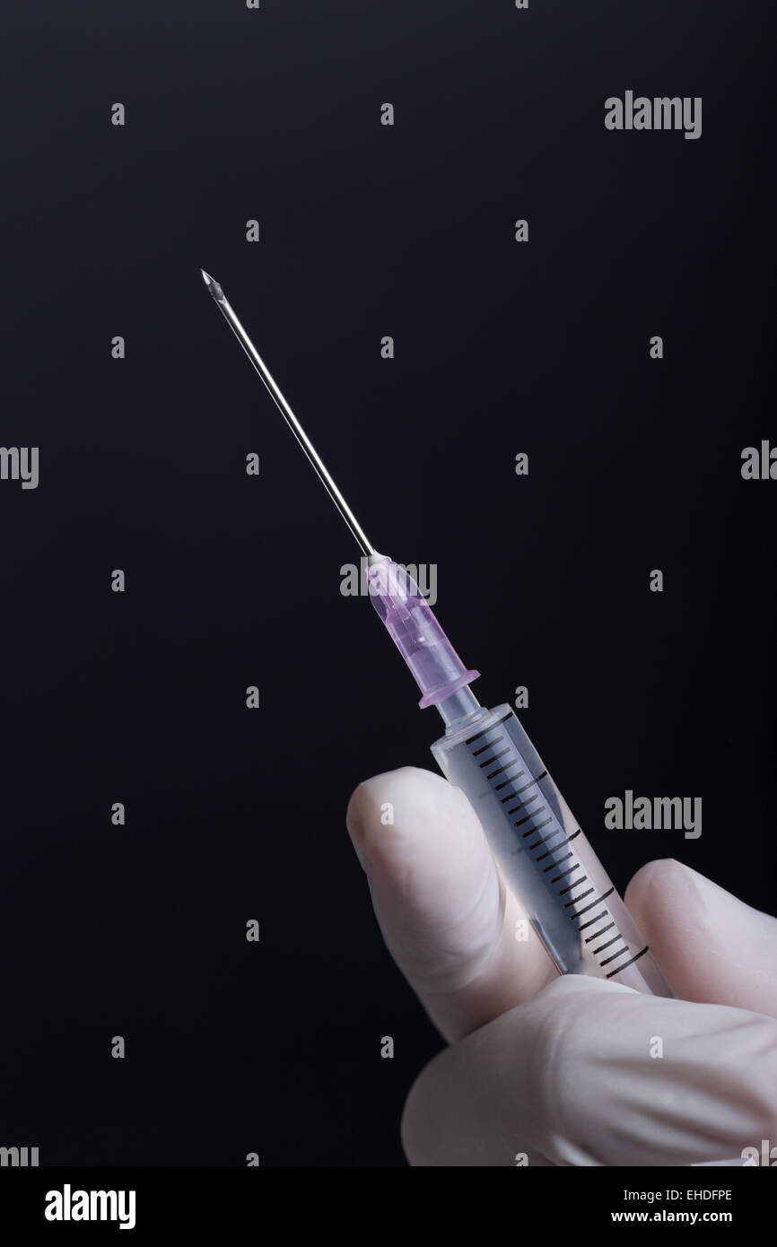 Hand with syringe Stock Photo - Alamy