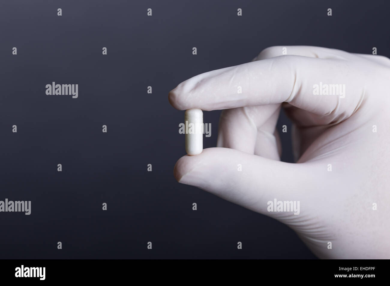 Hand with capsule Stock Photo - Alamy