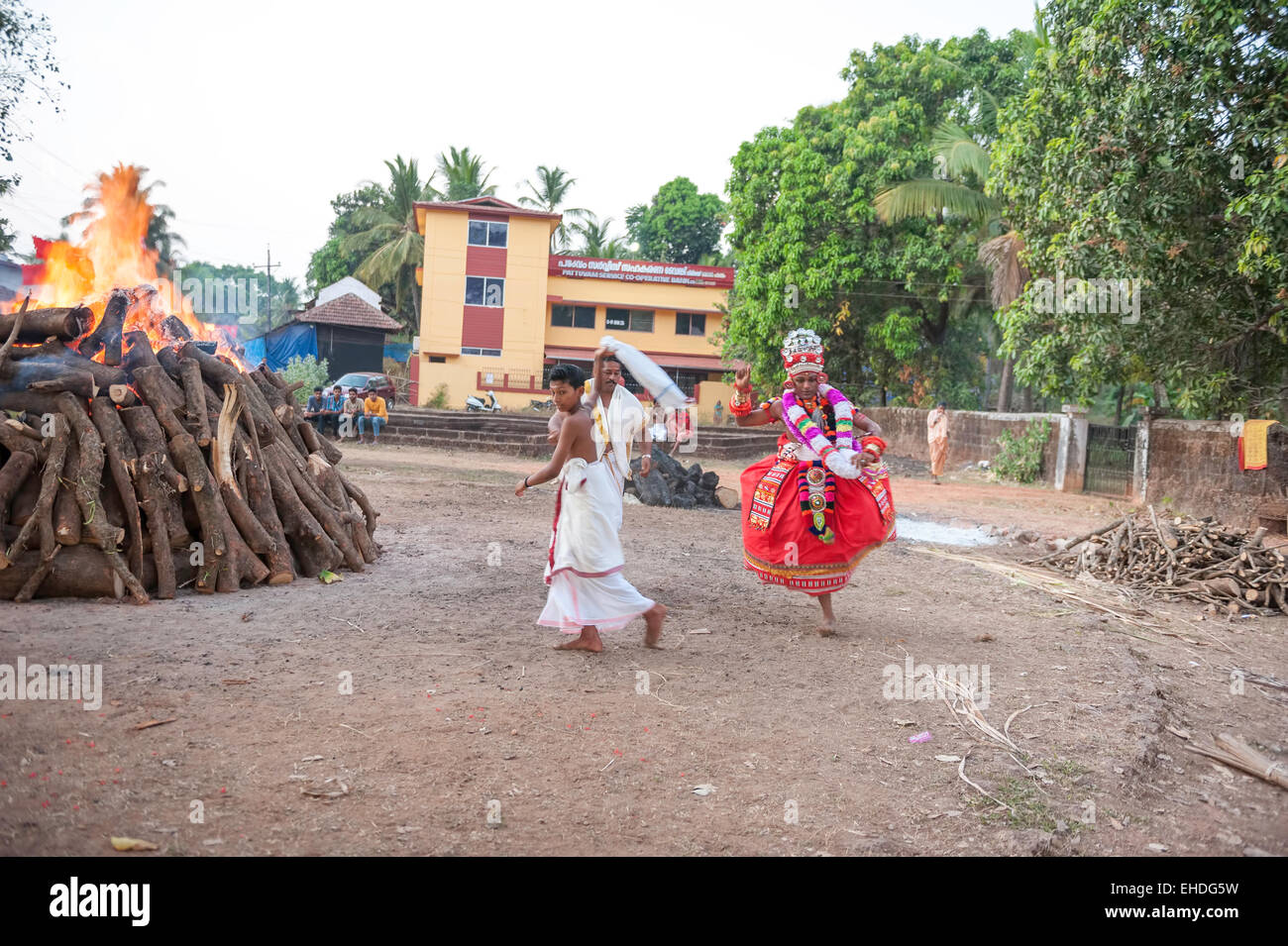 Theyyam Dancer walking around fire as a part of rituals Stock Photo - Alamy