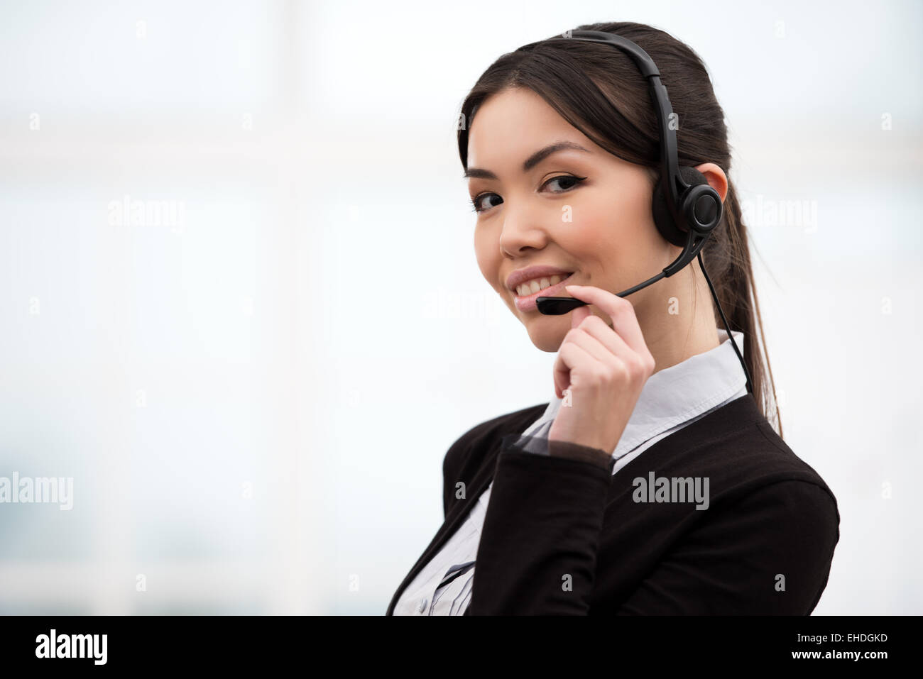 Asian call center female operator using headphones Stock Photo - Alamy