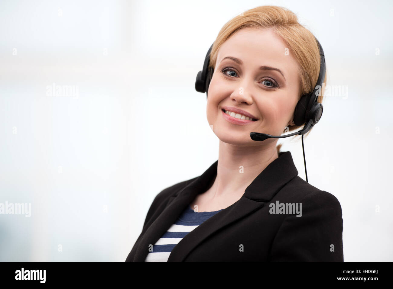 Young call center female operator with headphones Stock Photo - Alamy