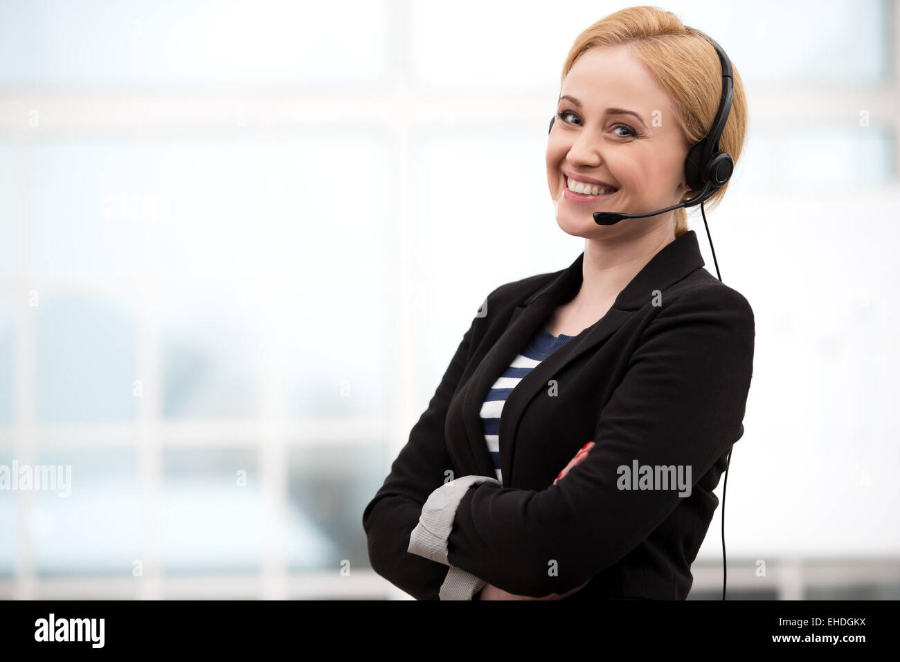 Smiling call center female operator with headphones Stock Photo - Alamy