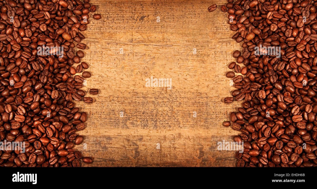 Roasted coffee beans on rustic wood Stock Photo - Alamy
