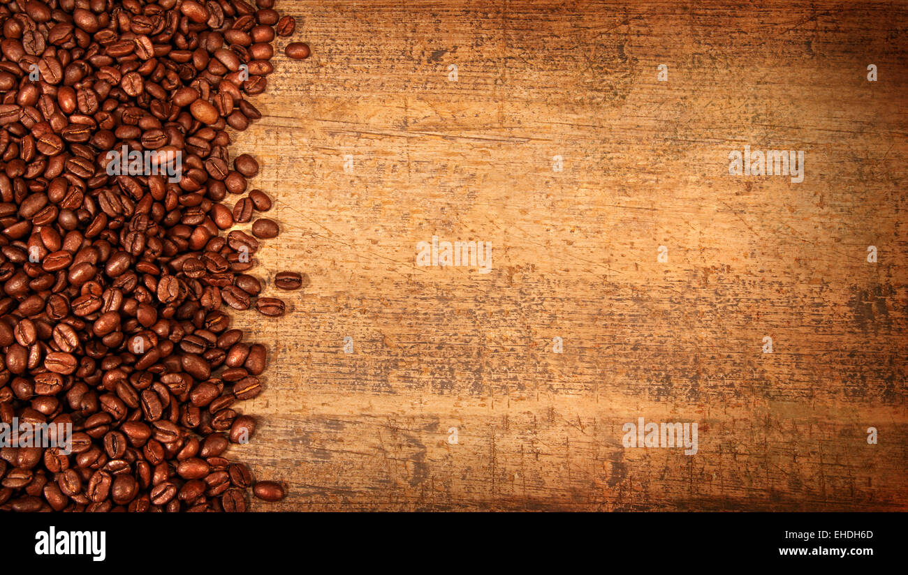 Roasted coffee beans on rustic wood Stock Photo - Alamy