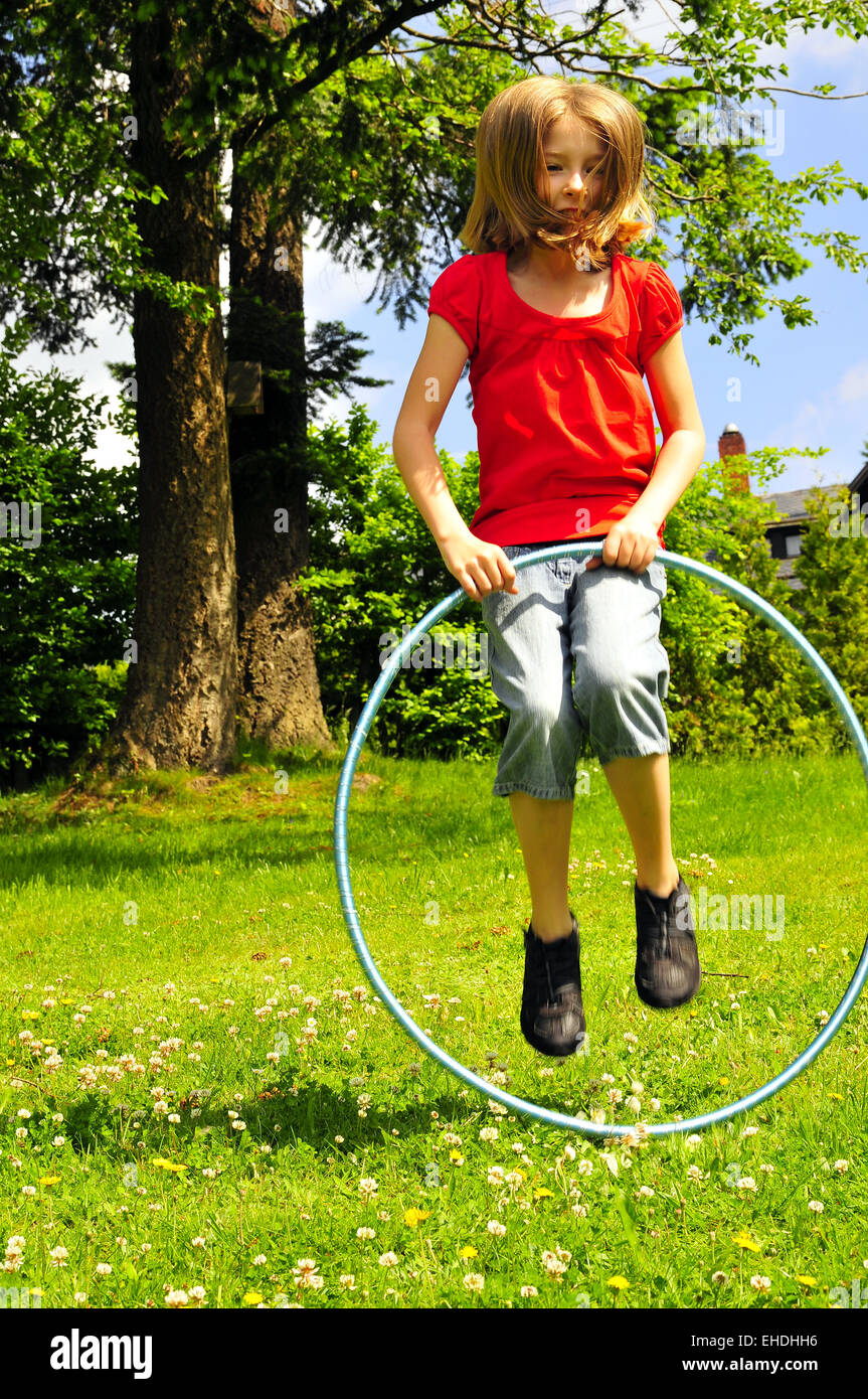 Child in the garden hopping jumping Stock Photo - Alamy
