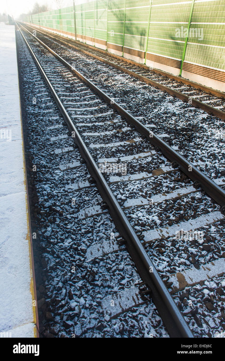 railroad tracks and big, green sound-screen Stock Photo - Alamy