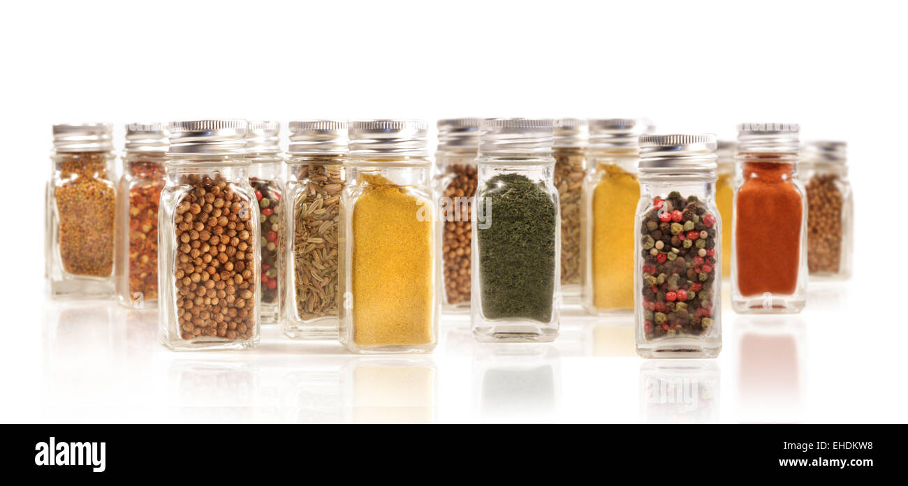 Assorted spice bottles isolated on white Stock Photo - Alamy