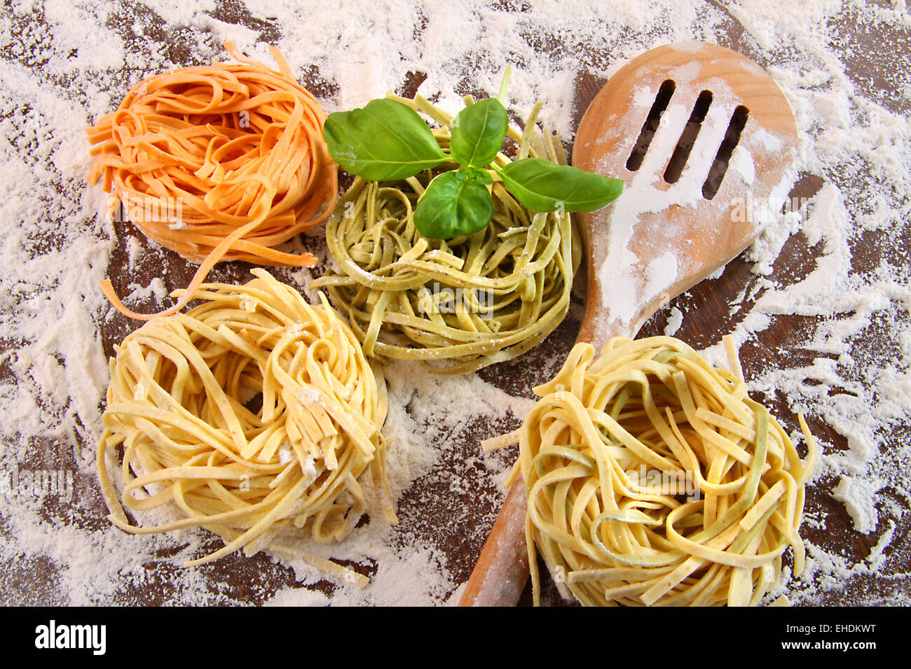Uncooked italian pasta in three colours Stock Photo - Alamy