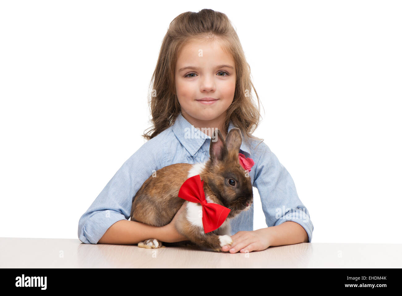 Girl looking at camera with bunny Stock Photo - Alamy