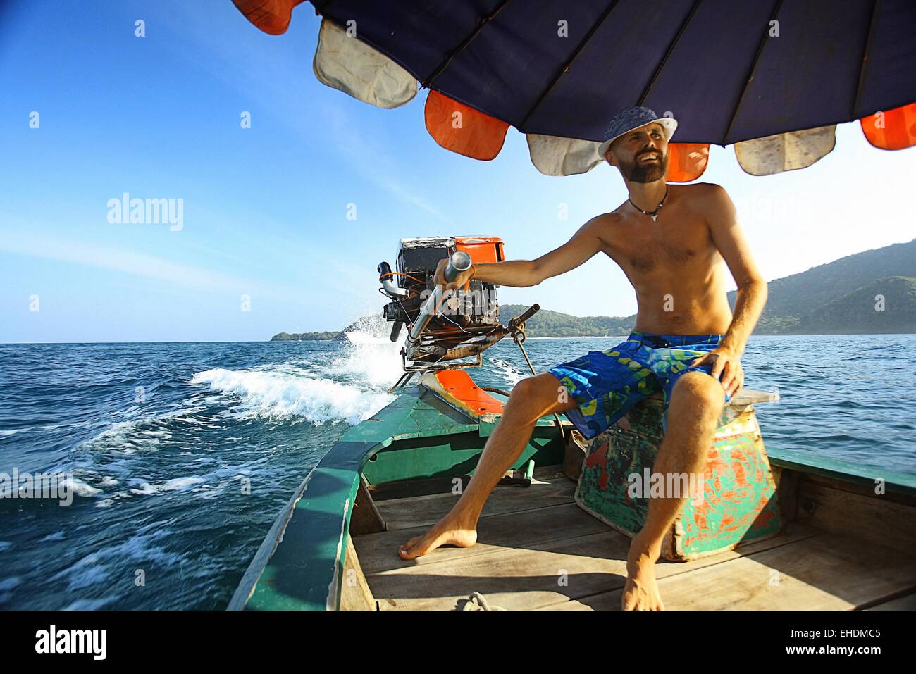 tanned man on the boat thailand vacation Stock Photo - Alamy