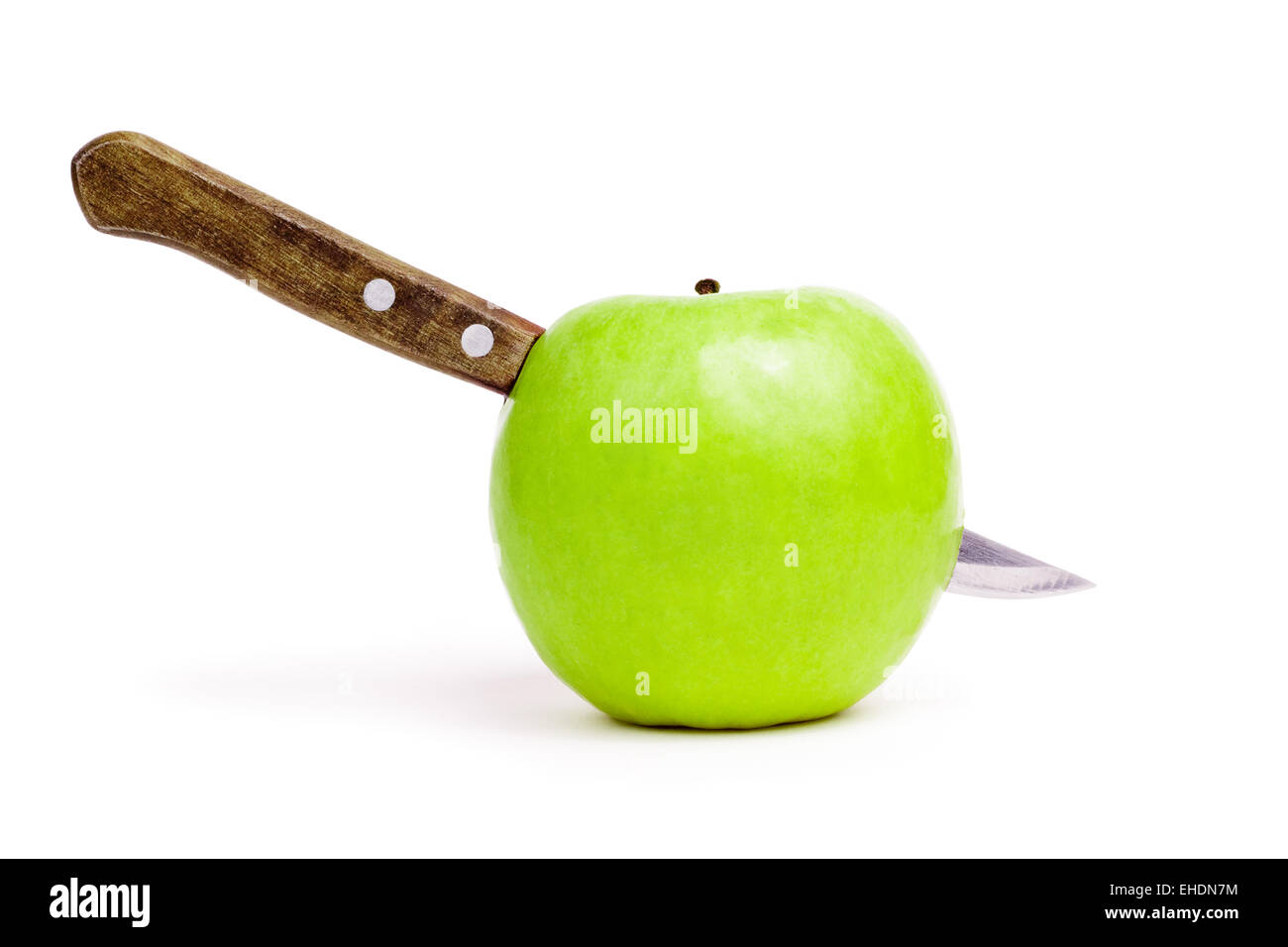 knife in the apple over white background Stock Photo - Alamy