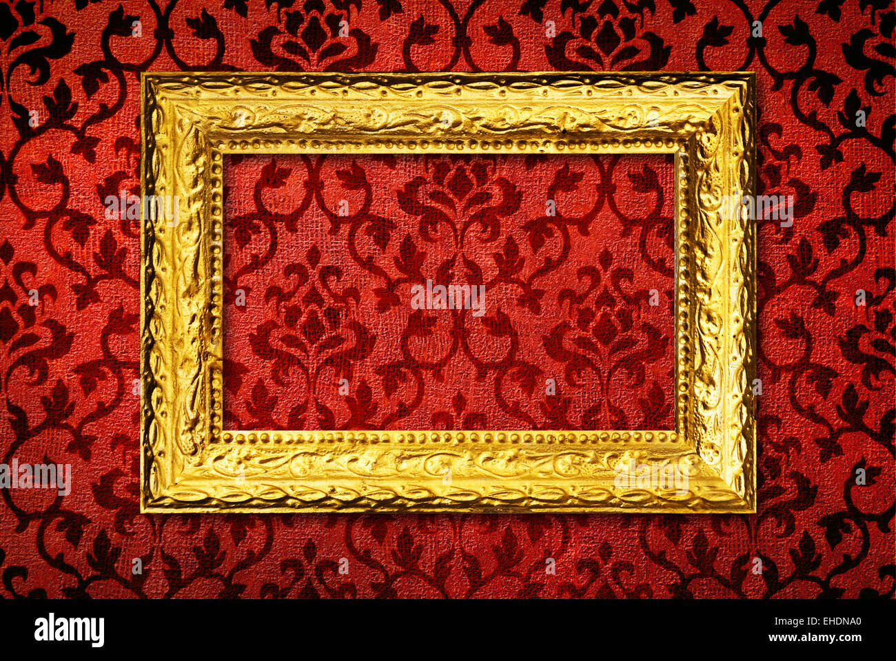 Gold frame on a vintage red wall background Stock Photo - Alamy