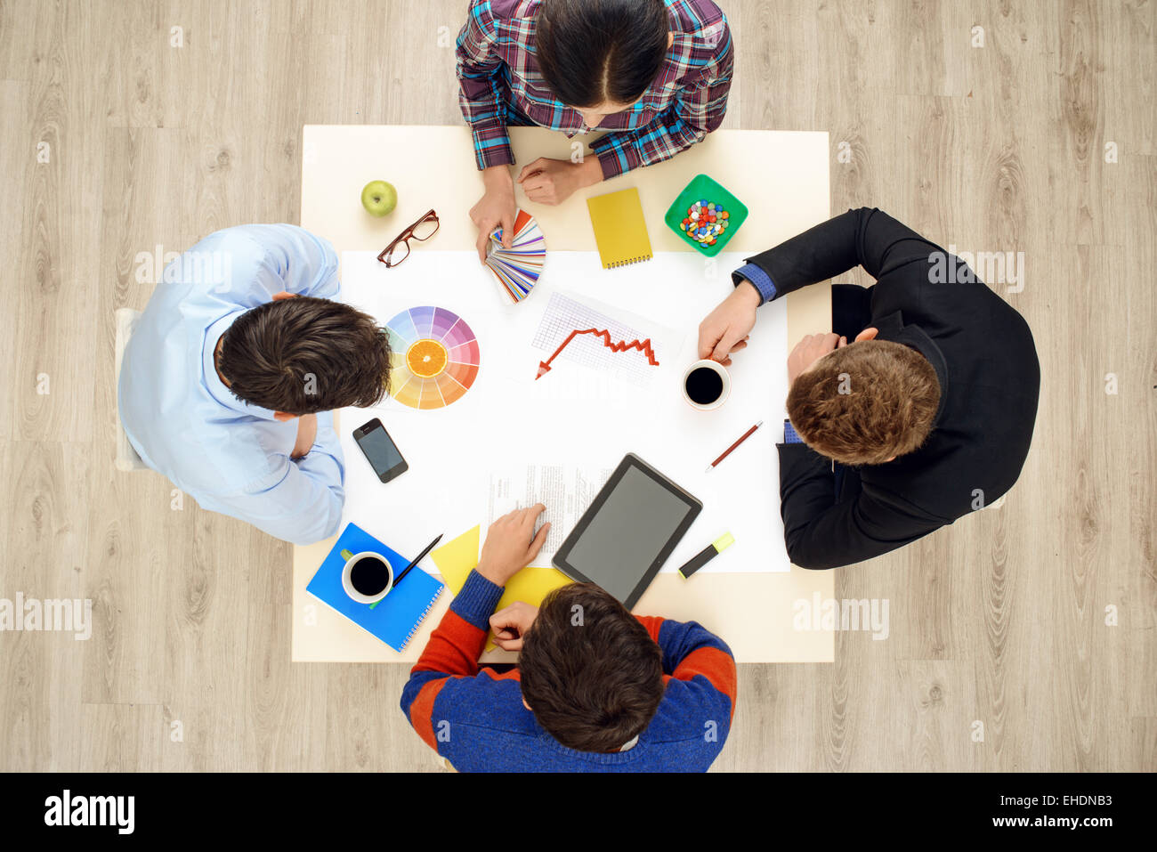 Top view table with creative people and gadgets Stock Photo - Alamy