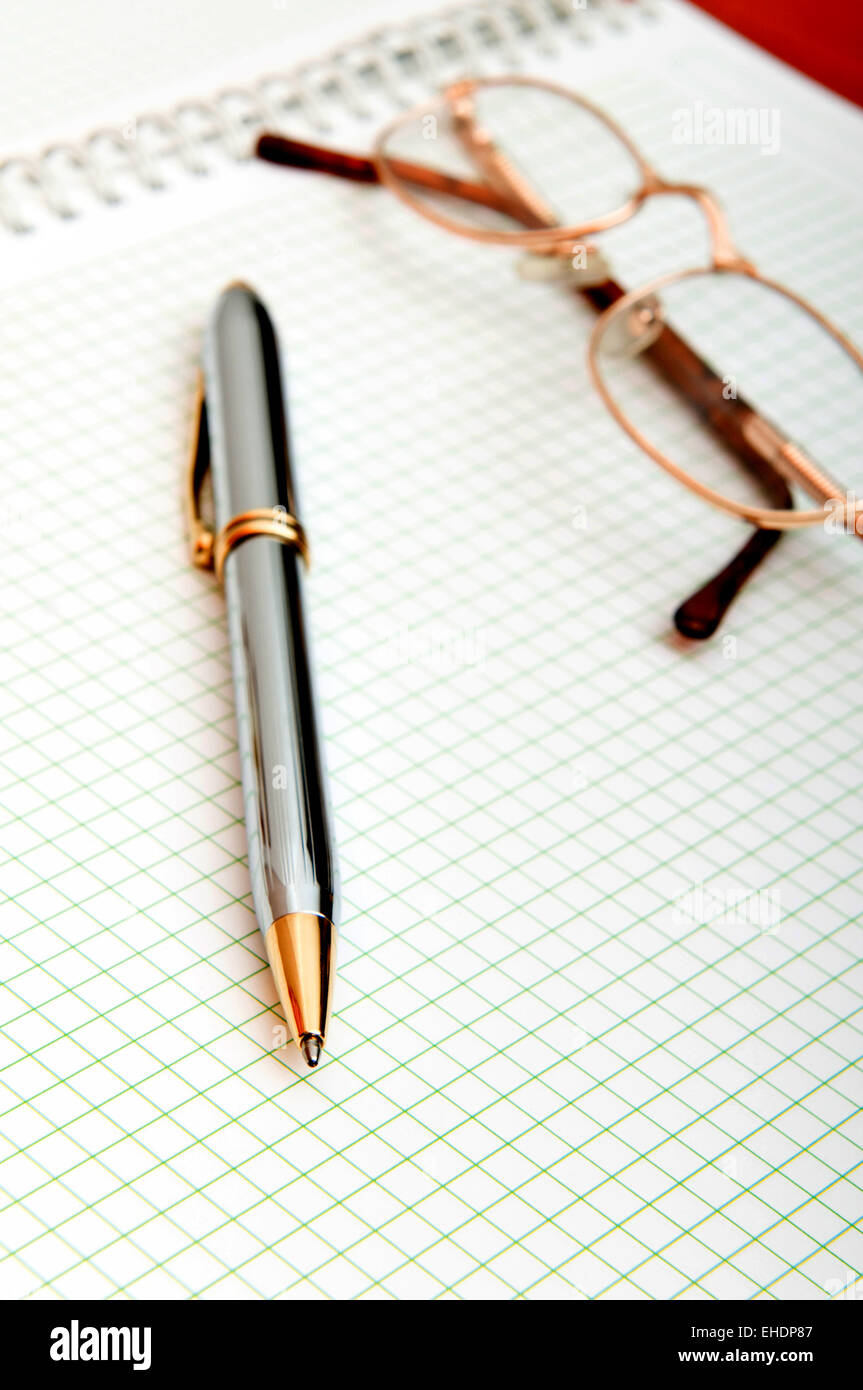 Pen and eye glasses on the page Stock Photo - Alamy
