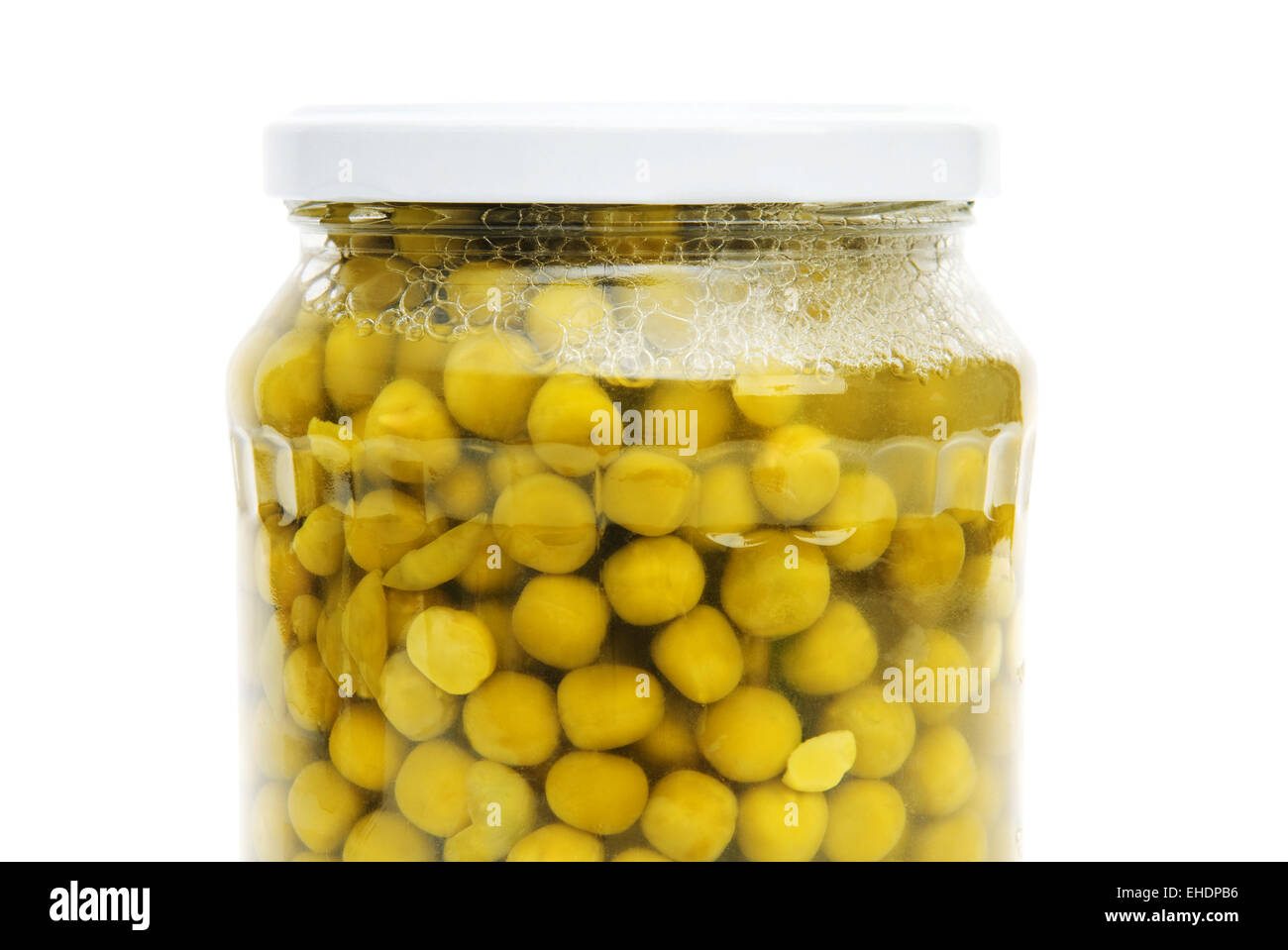 Green peas in glass jar isolated on white Stock Photo - Alamy