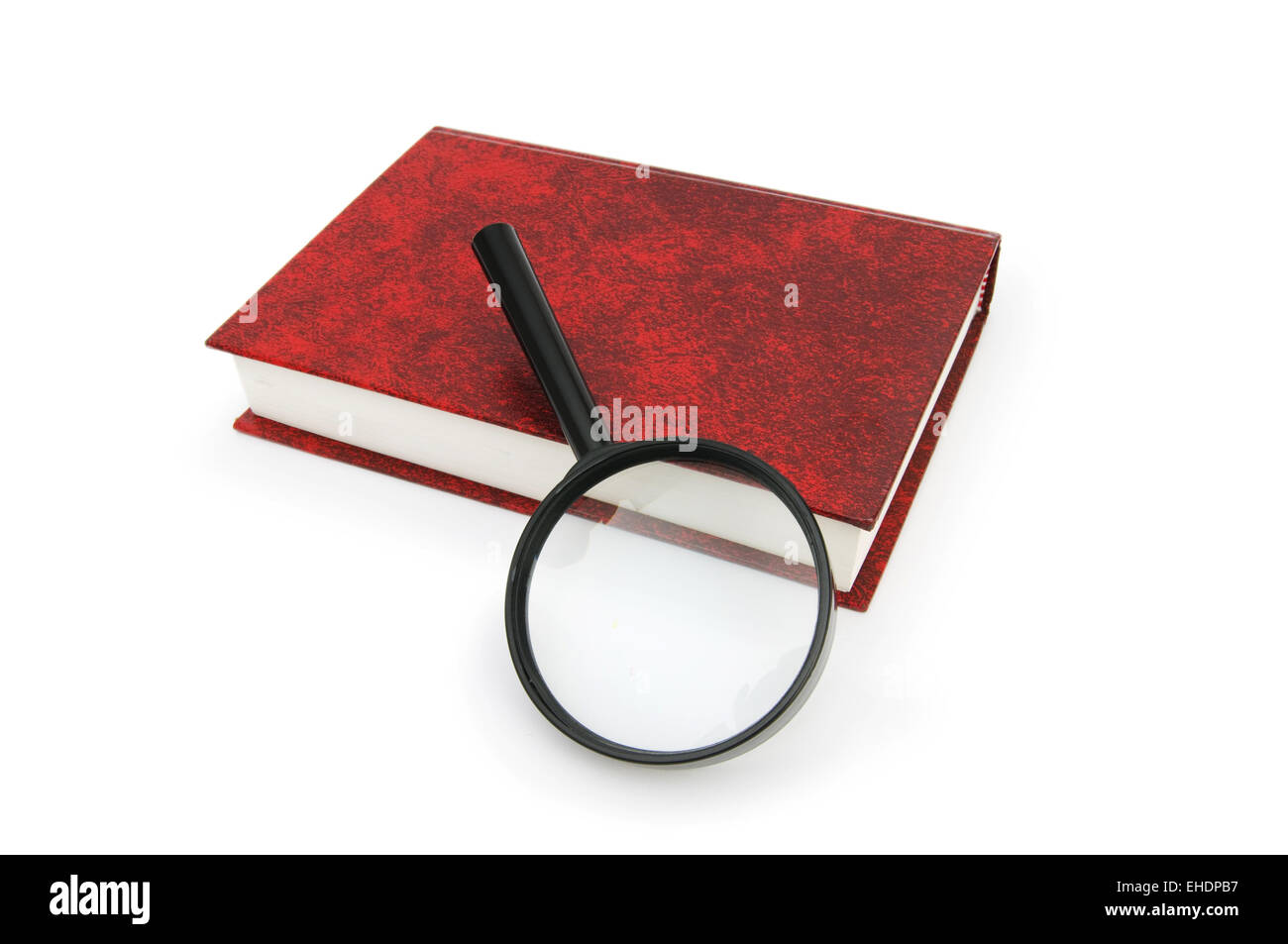 Magnifying glass over the stack of books Stock Photo - Alamy