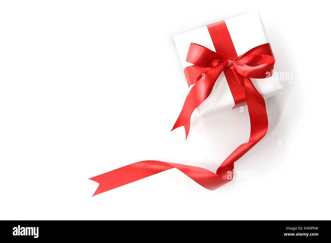 Red ribbon gift on white Stock Photo - Alamy