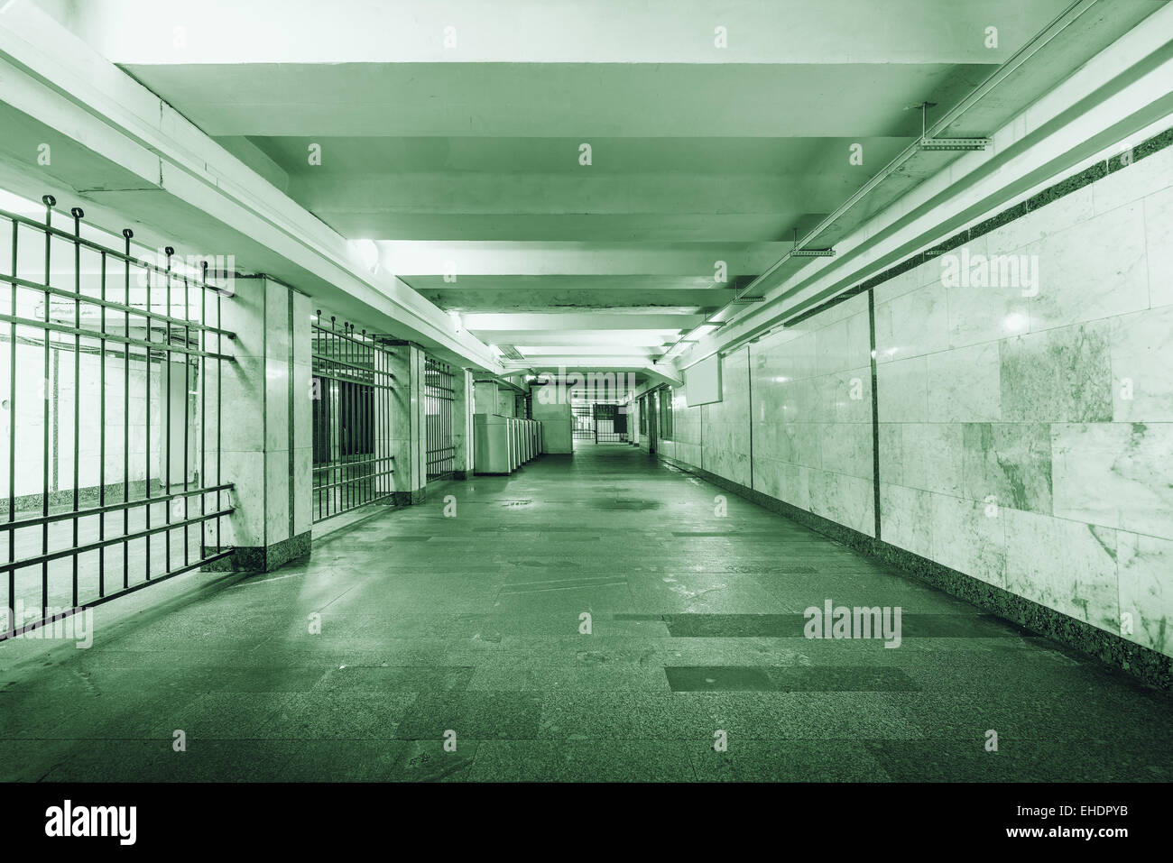 Dark and long undergorund passage with light Stock Photo - Alamy