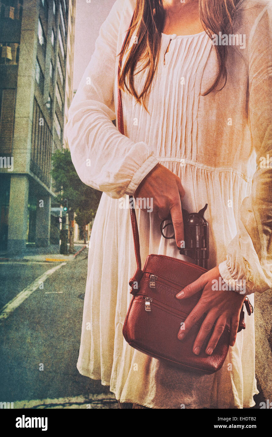 Woman with a handgun about to rob a shop Stock Photo - Alamy