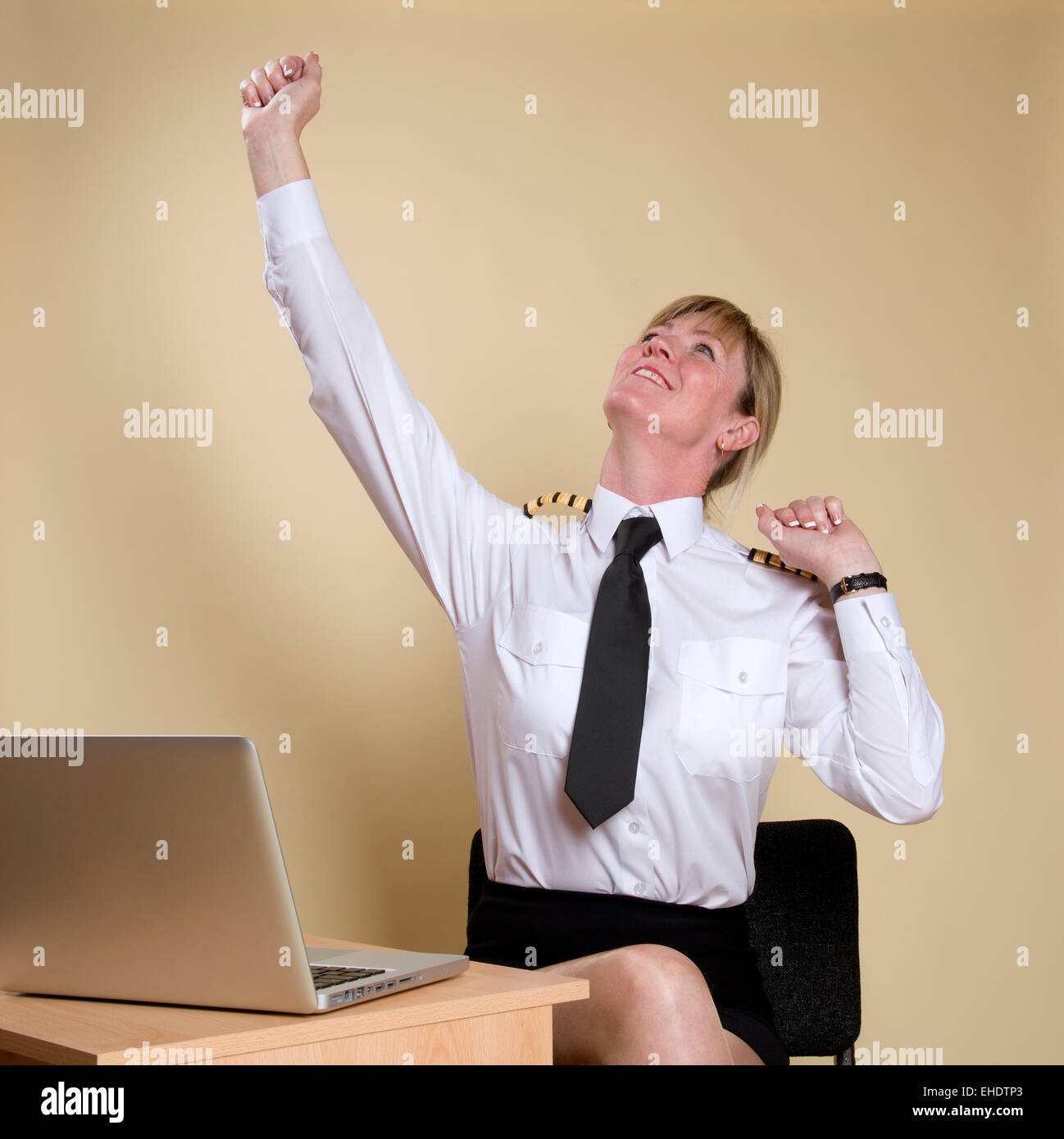 Tired female airline pilot wearing insignia of a captain taking a ...