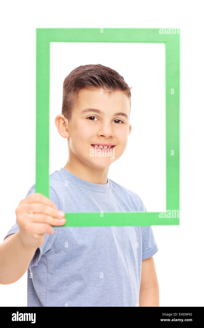 Cute little boy posing behind a picture frame isolated on white ...