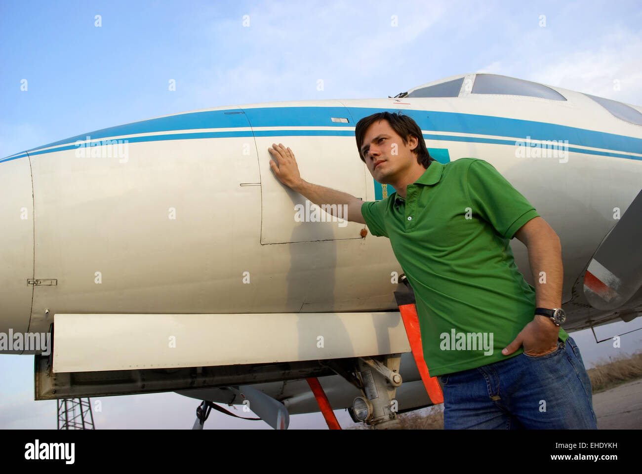 Young man beside airplane Stock Photo - Alamy