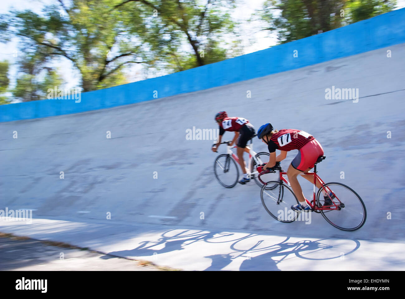 Two cyclist fast racing on velodrome Stock Photo - Alamy