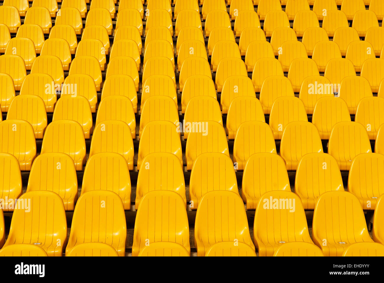Yellow stadium seats background Stock Photo - Alamy