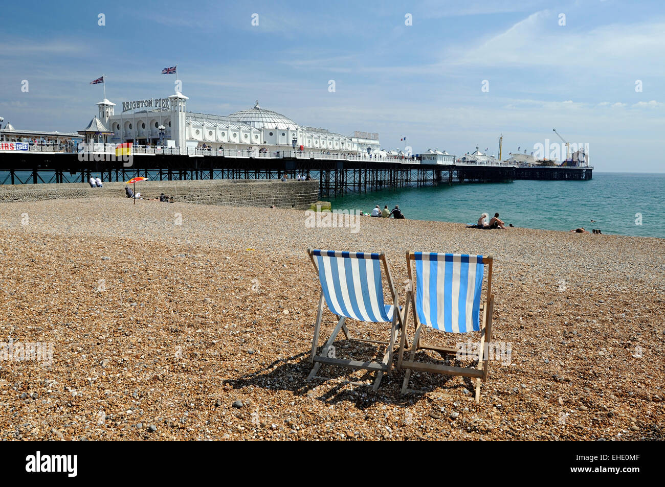 Two blue white beach chairs at pier and beachfront in brighton, east ...