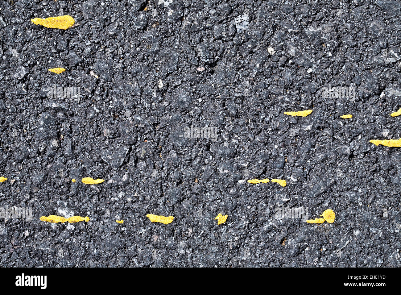 Asphalt texture with yellow spots Stock Photo - Alamy