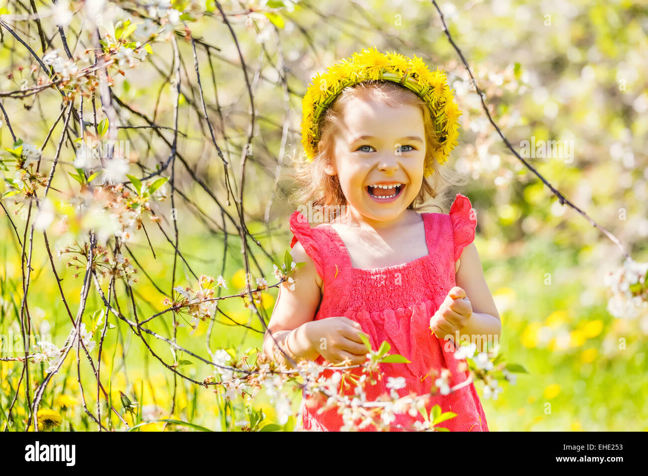Happy little girl in spring sunny park Stock Photo - Alamy