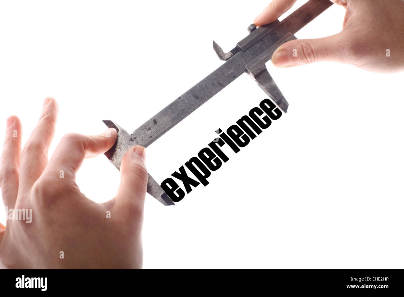 Color horizontal shot of two hands holding a caliper measuring the word ...