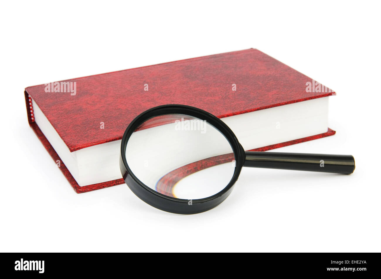 Magnifying glass over the stack of books Stock Photo - Alamy